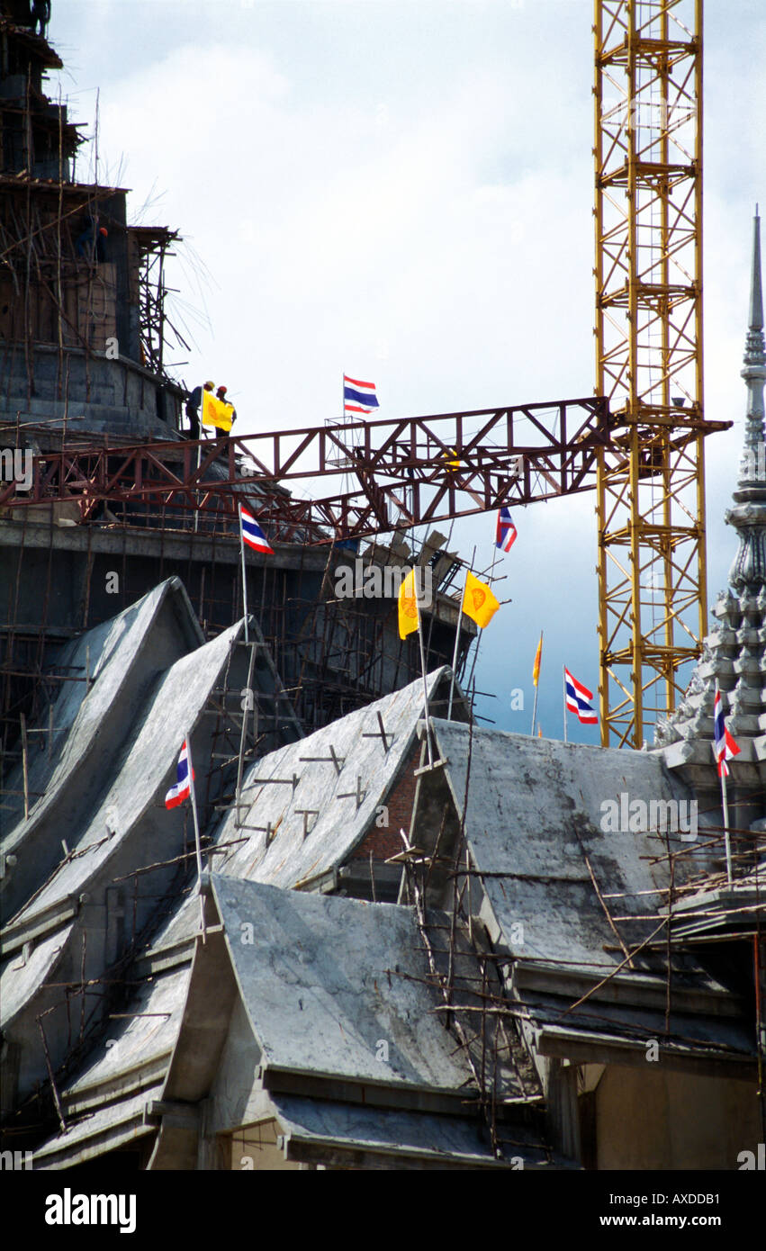Thailand temple construction showing Thai flags, building cranes ...