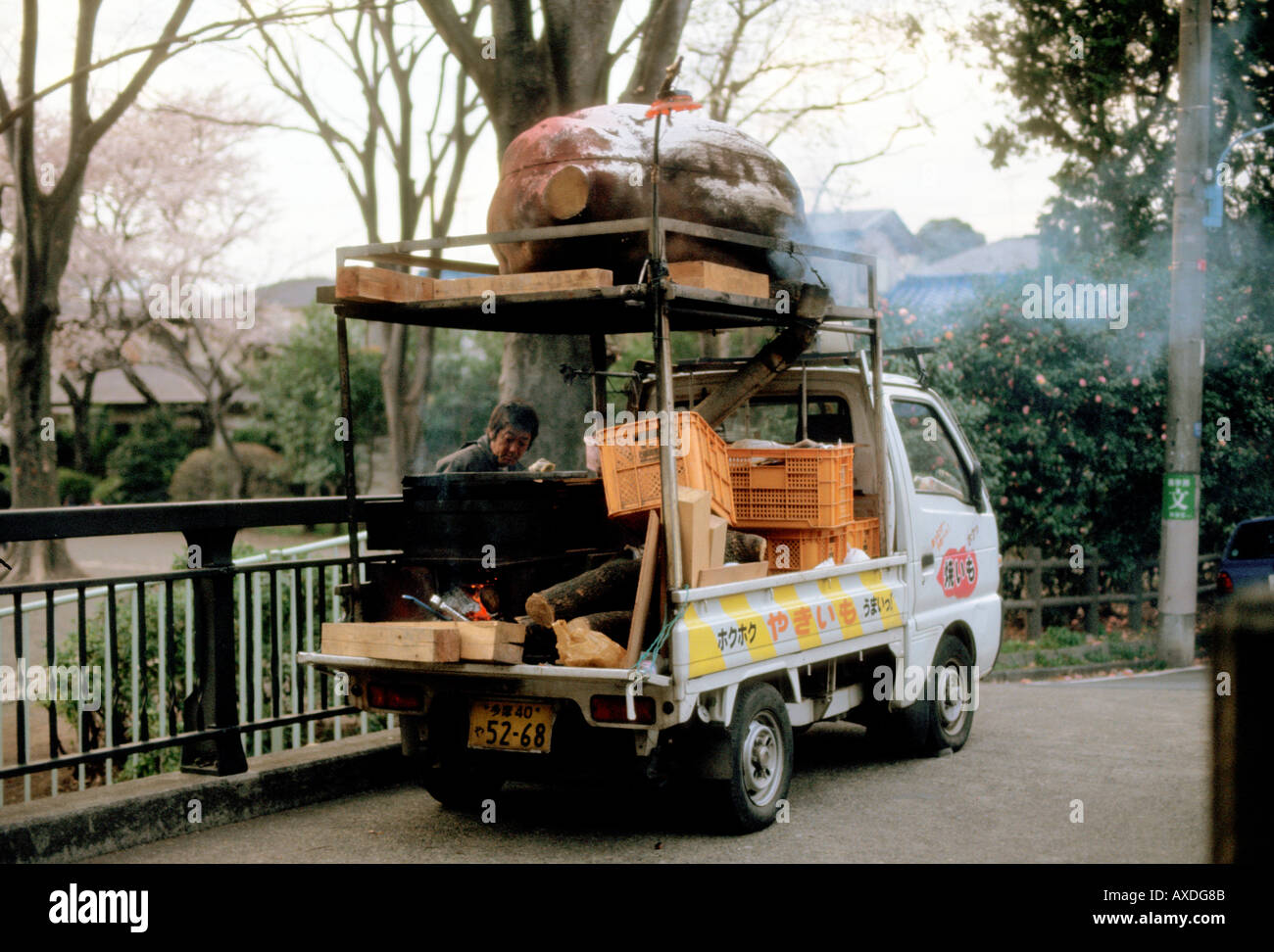 Traditional Yaki Imo roasted sweet potato vendor and potato topped ...