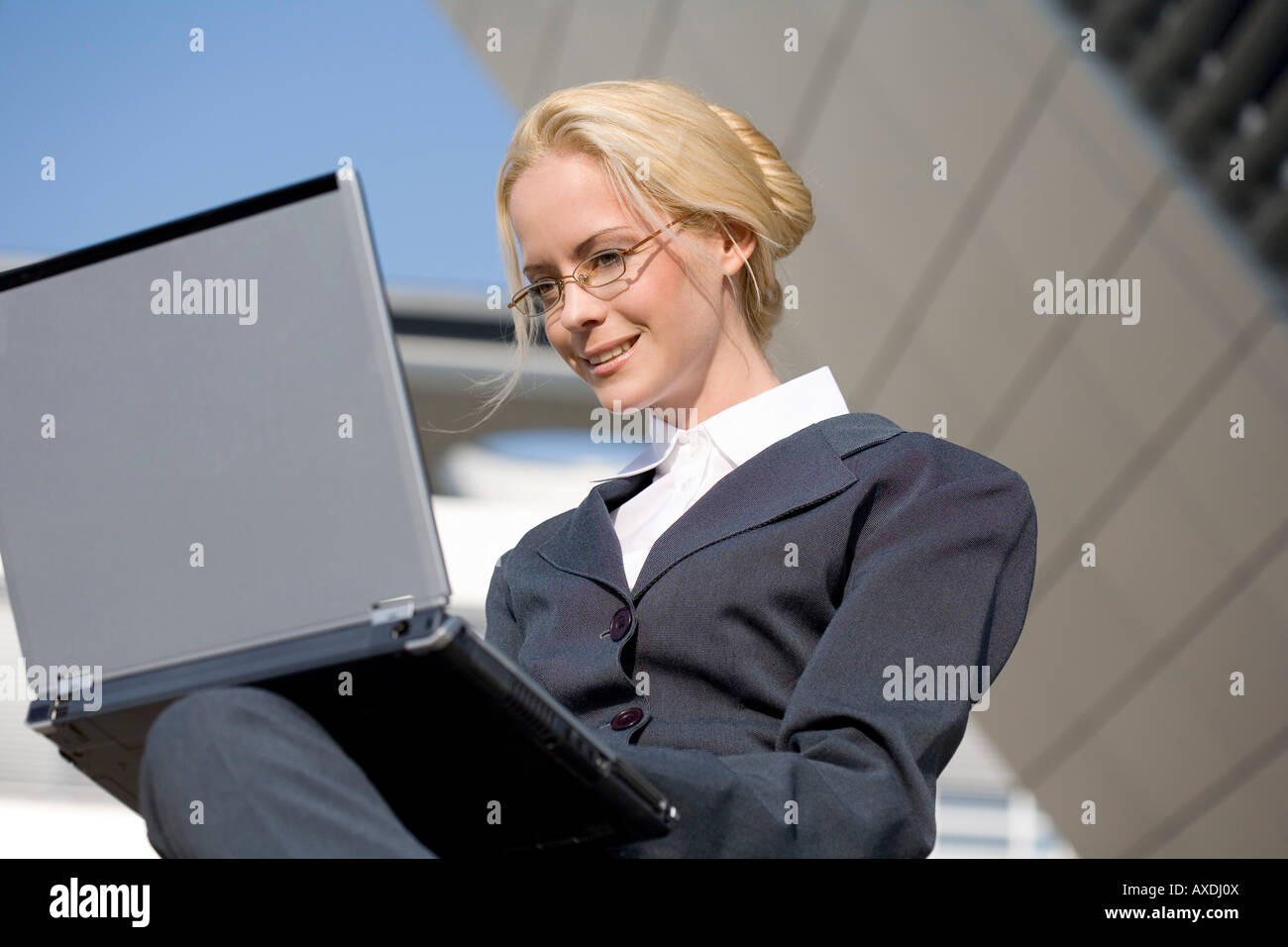 Business woman using laptop, portrait Stock Photo - Alamy
