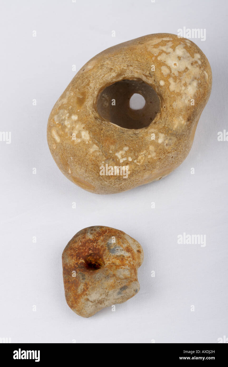 Two stones with natural holes in on plain white background Stock Photo ...