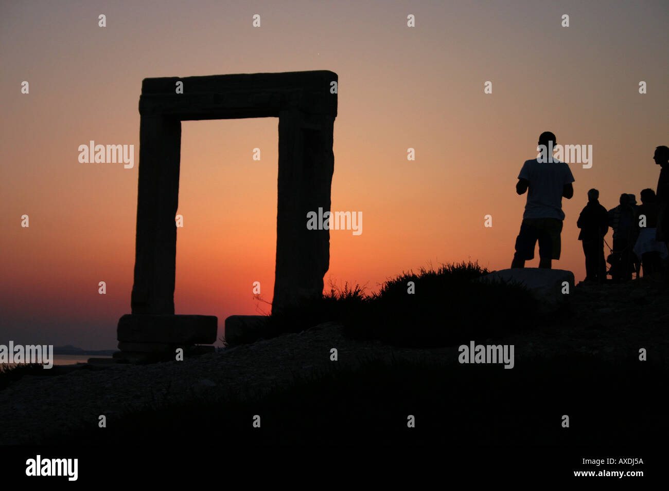 Arch of the Temple of Apollo at sunset A few silhouetted people share ...