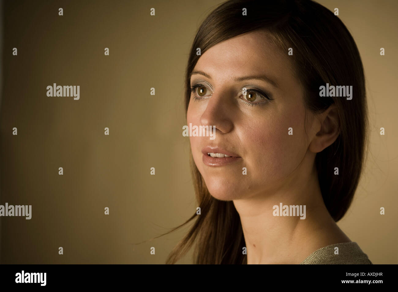 Portrait of female model, brown background Stock Photo - Alamy
