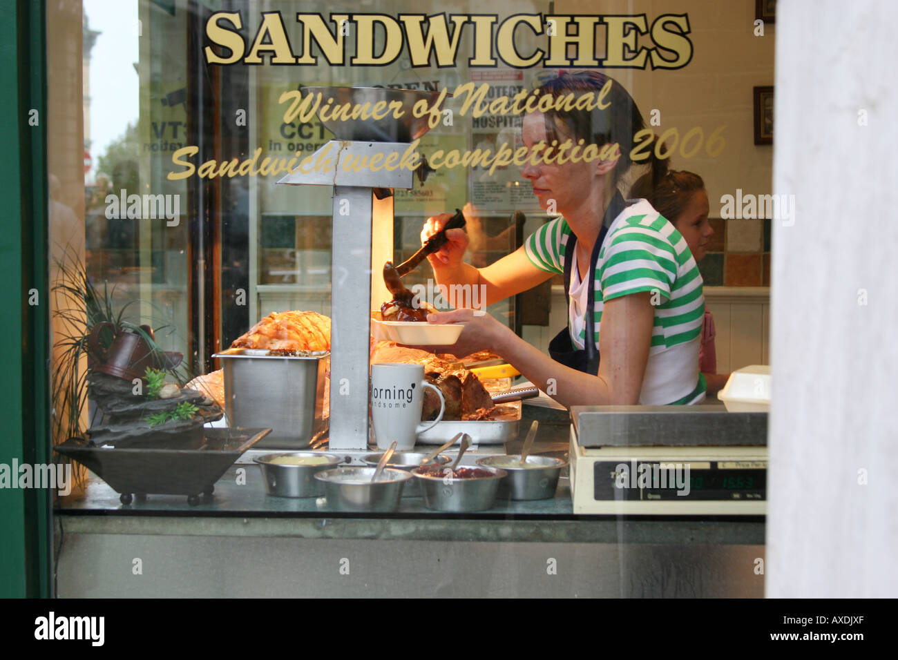 Woman serving food in a sandwich roast meat shop Stock Photo - Alamy