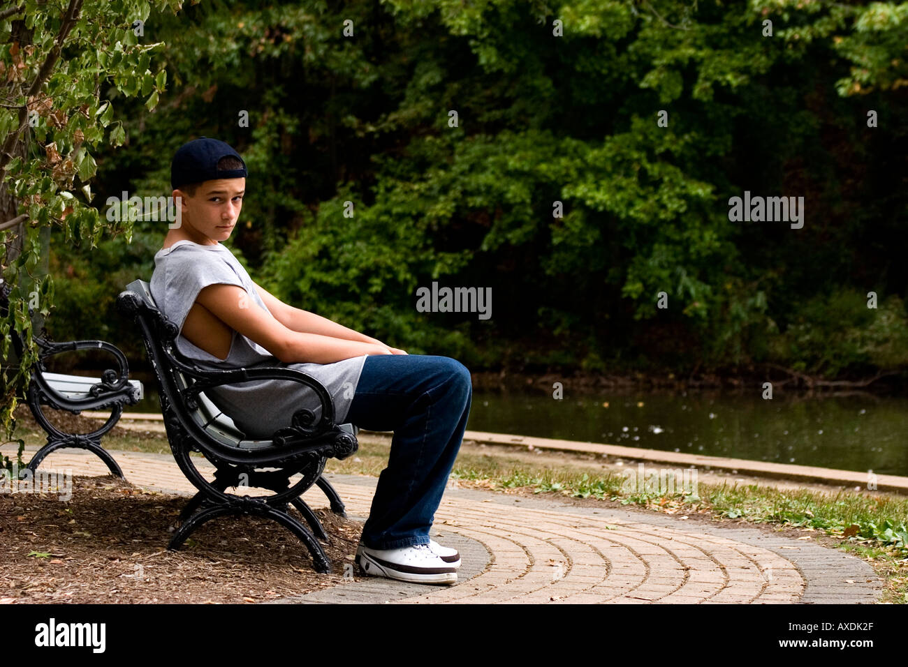 Teen bench sitting Stock Photo - Alamy
