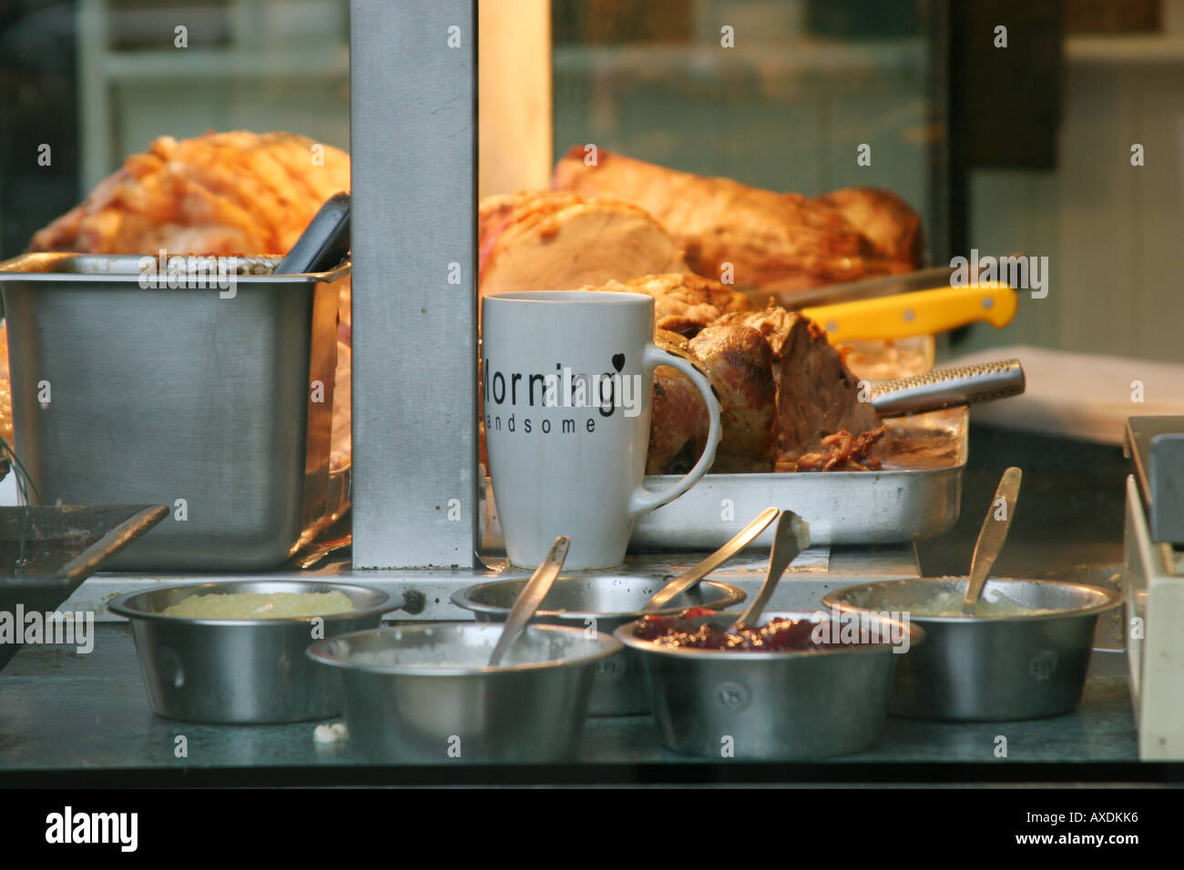 Kitchen area in fast food shop with meat joints, knives; dishes of ...