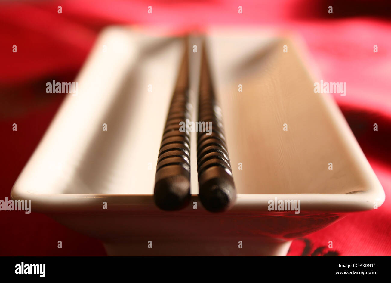Chopsticks on a bowl in a formal dinner setting Stock Photo - Alamy