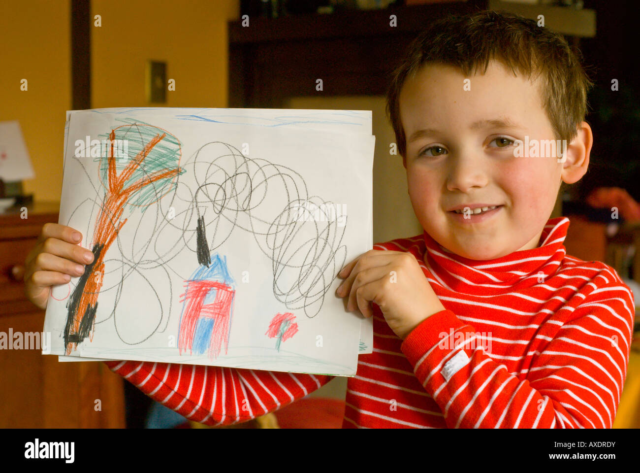 boy proudly holding up his drawing Stock Photo - Alamy
