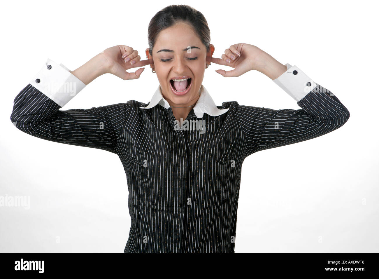 Adult woman putting finger in her ears and shouting Stock Photo - Alamy