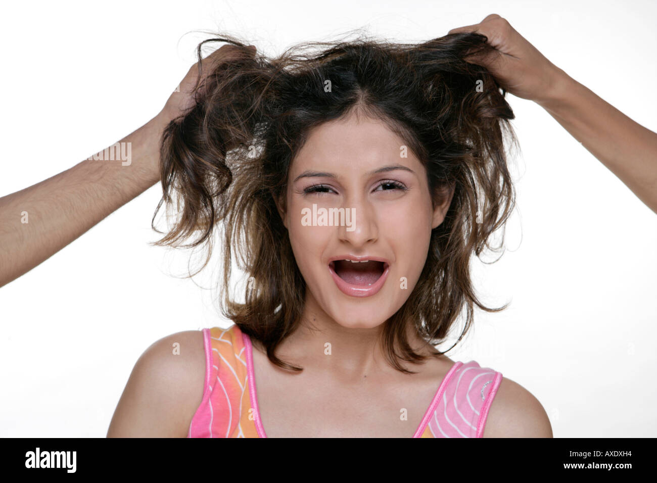 Two hands pulling hair of a young woman Stock Photo - Alamy