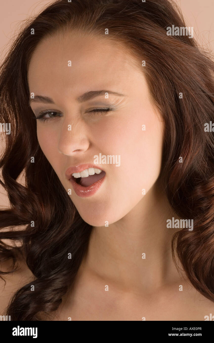 Young woman winking, close-up, portrait Stock Photo - Alamy