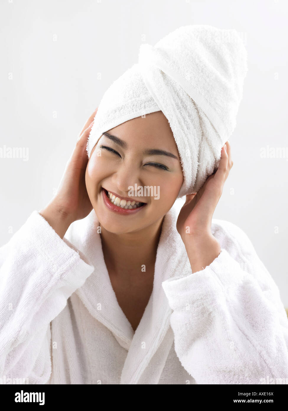 Young female wrapping her head with a towel Stock Photo - Alamy