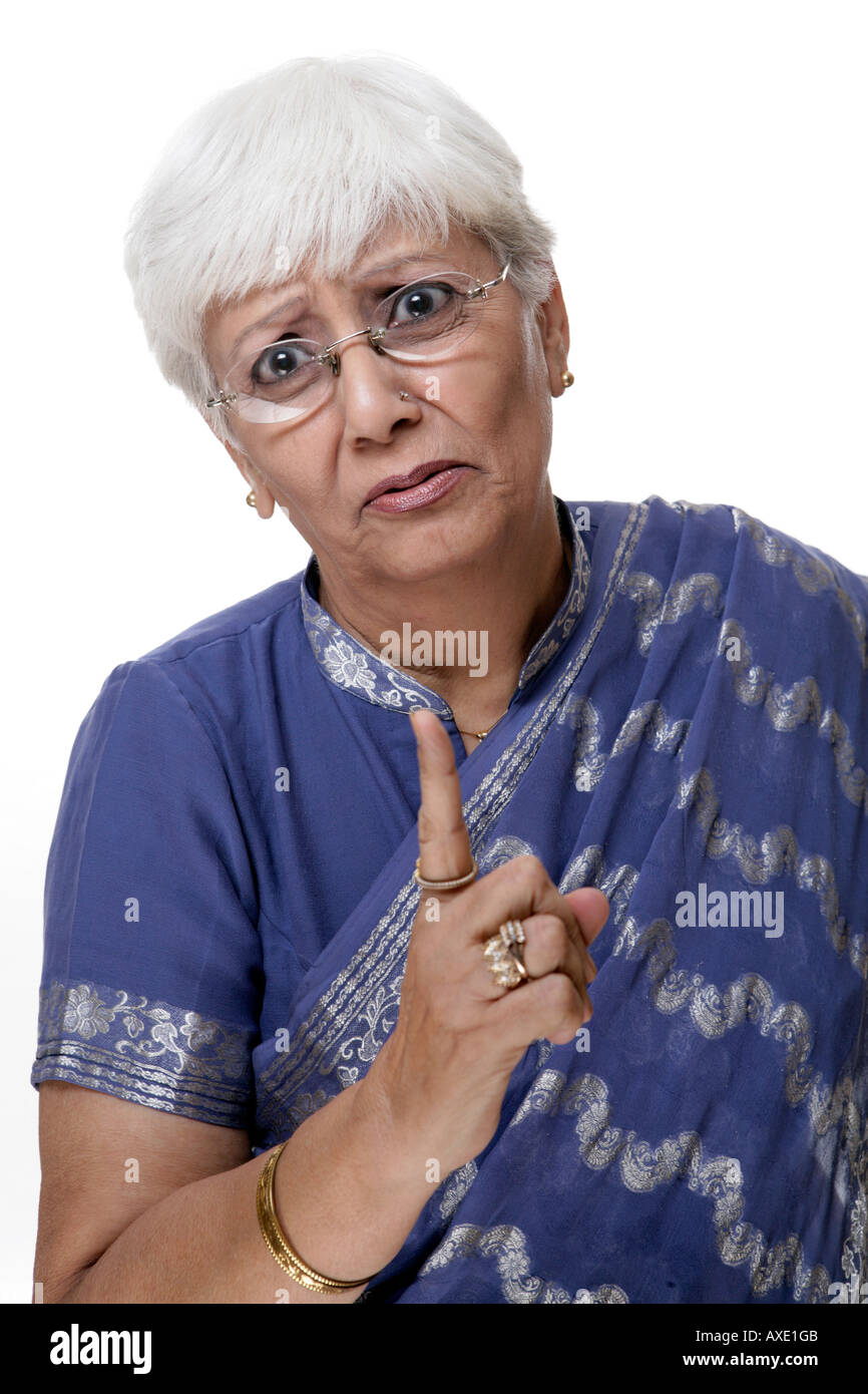 Portrait of a senior woman giving warning Stock Photo - Alamy