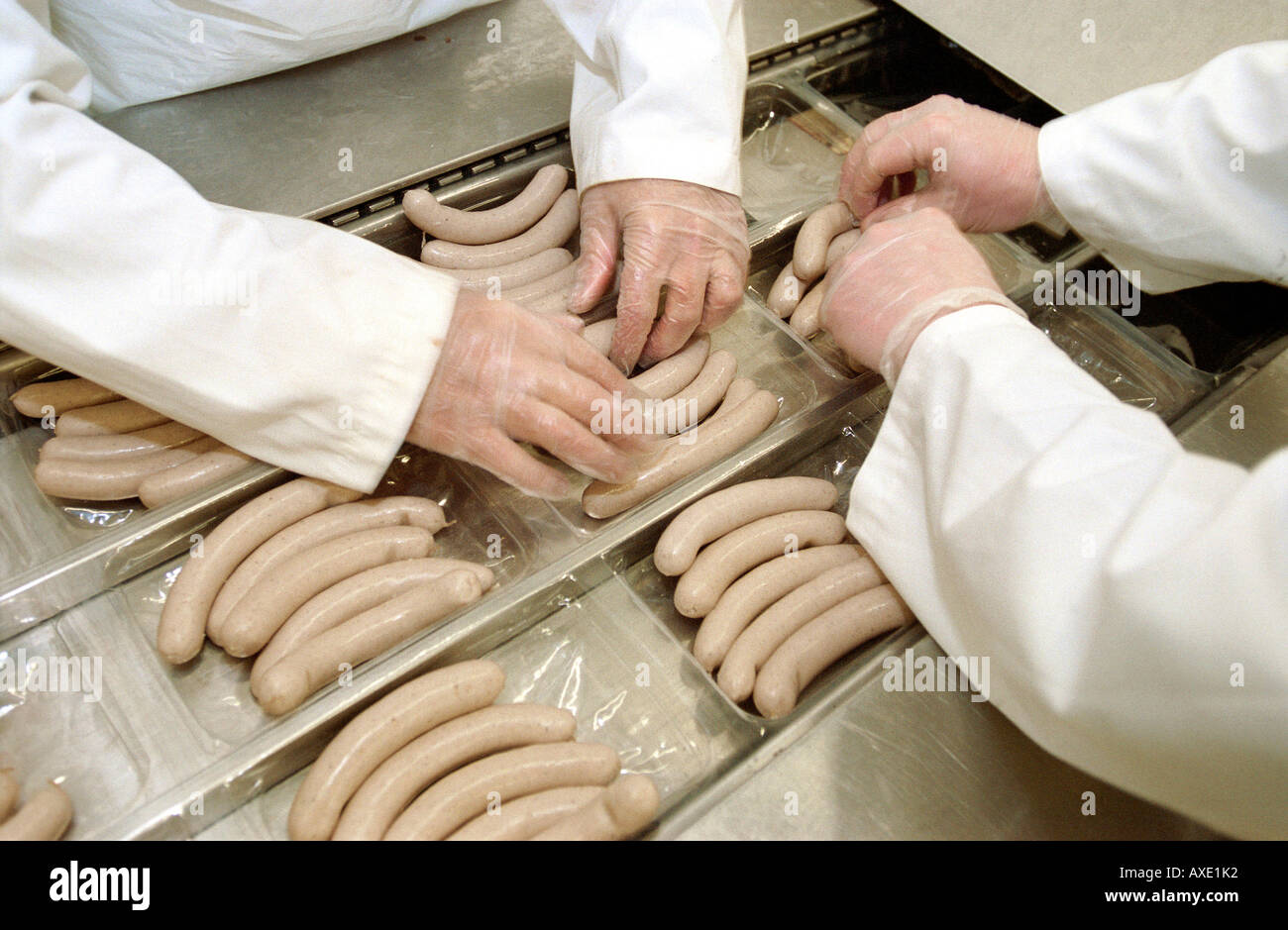 Butcher - packing sausages for self service Stock Photo - Alamy