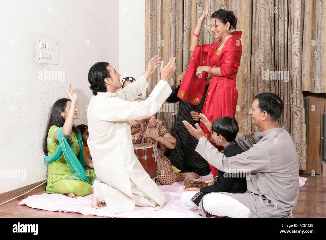 Joint family clapping and dancing Stock Photo - Alamy