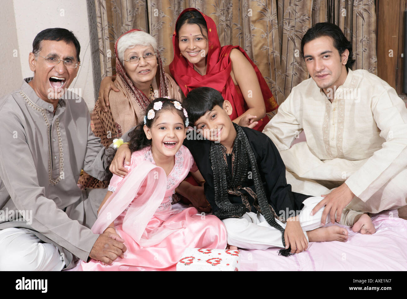 Joint family sitting in a bedroom Stock Photo - Alamy