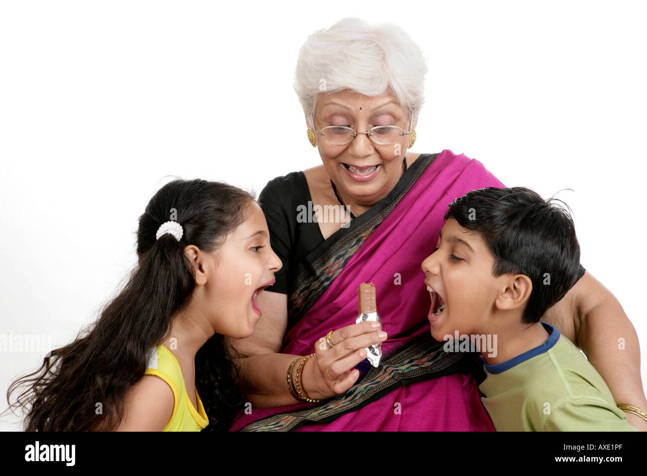 Grandmother giving chocolate to her grandchildren Stock Photo - Alamy