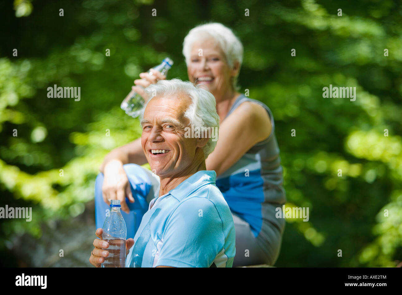 Senior couple taking a break, drinking water Stock Photo - Alamy