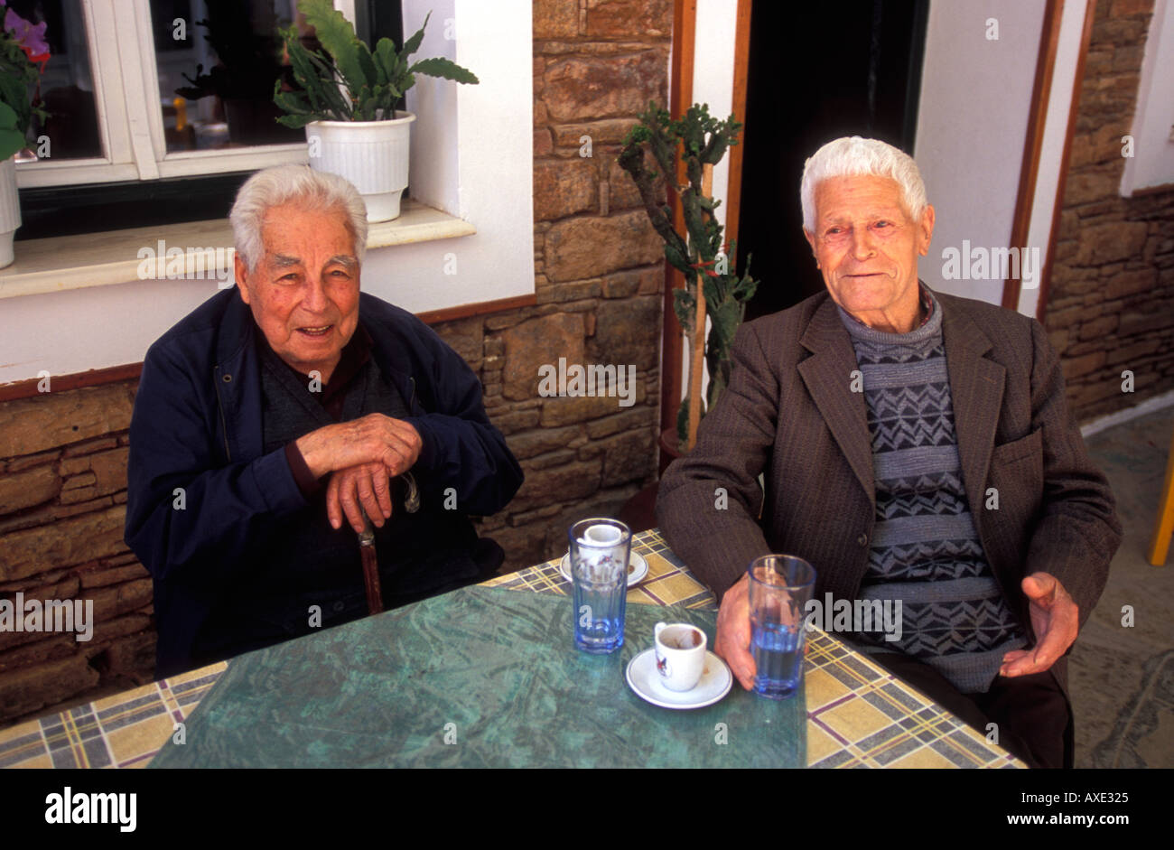 Two elderly Greek men sitting in a cafe, Platanos, Samos Island, Greece ...