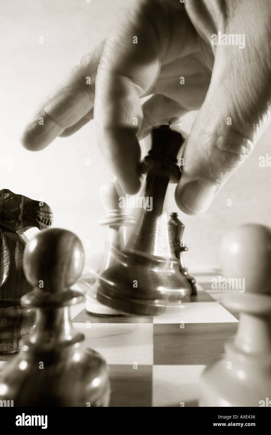 Hand moving chess piece Stock Photo - Alamy