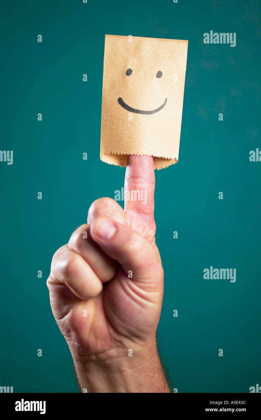 Happy face paper bag on finger Stock Photo - Alamy