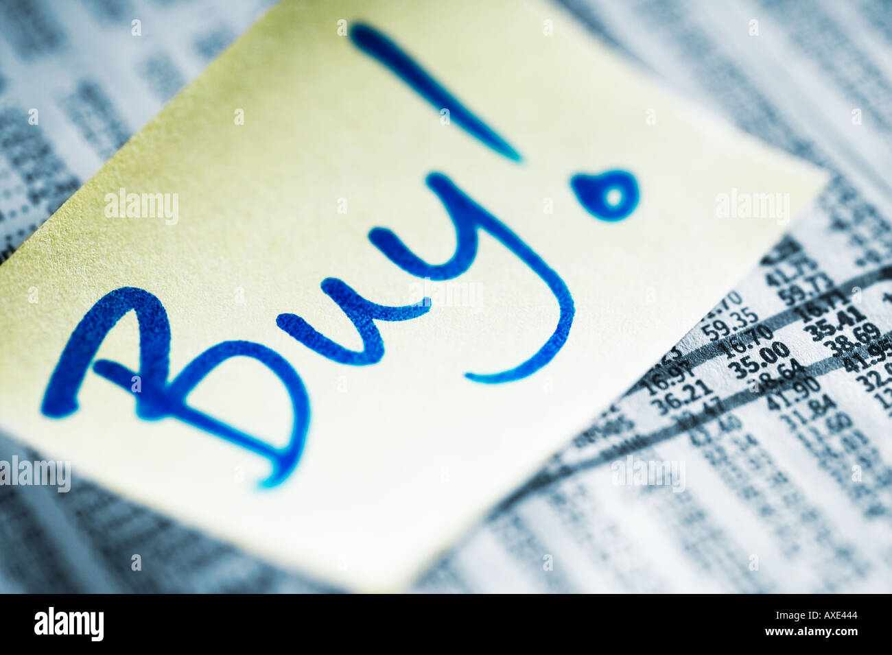 Yellow buy sticky on stock page Stock Photo - Alamy