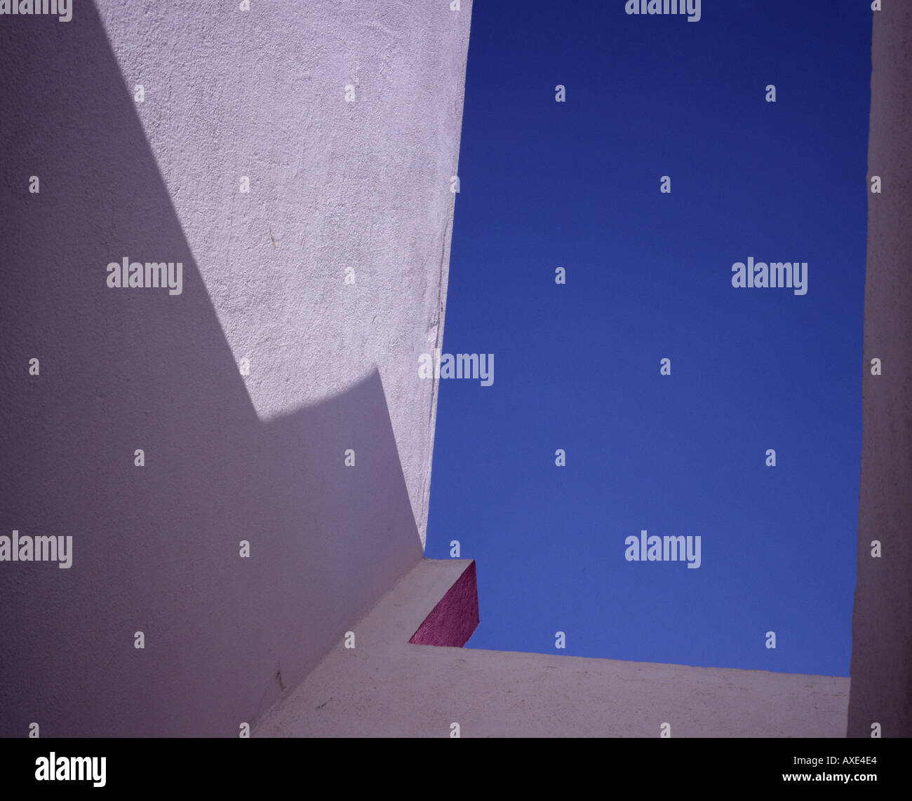 Modern architecture with white angular walls contrasting with blue sky ...
