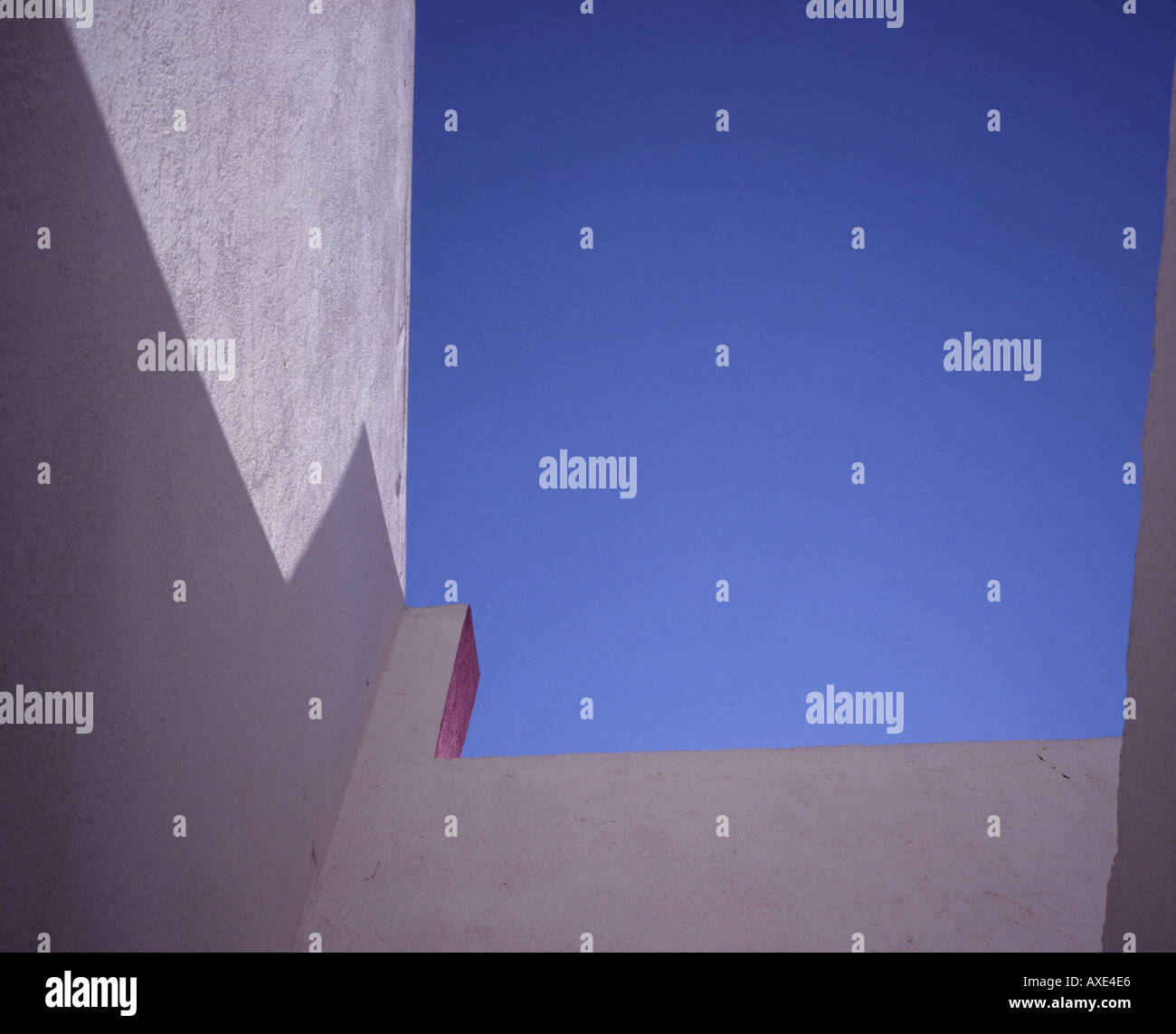 Modern architecture with white angular walls contrasting with blue sky ...