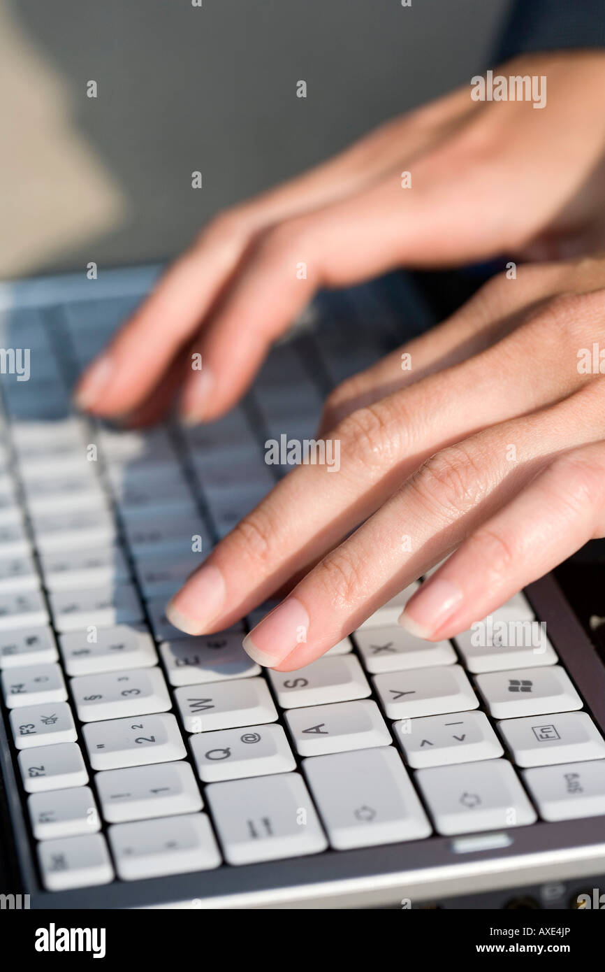 Female hand using keypad of laptop, close-up Stock Photo - Alamy