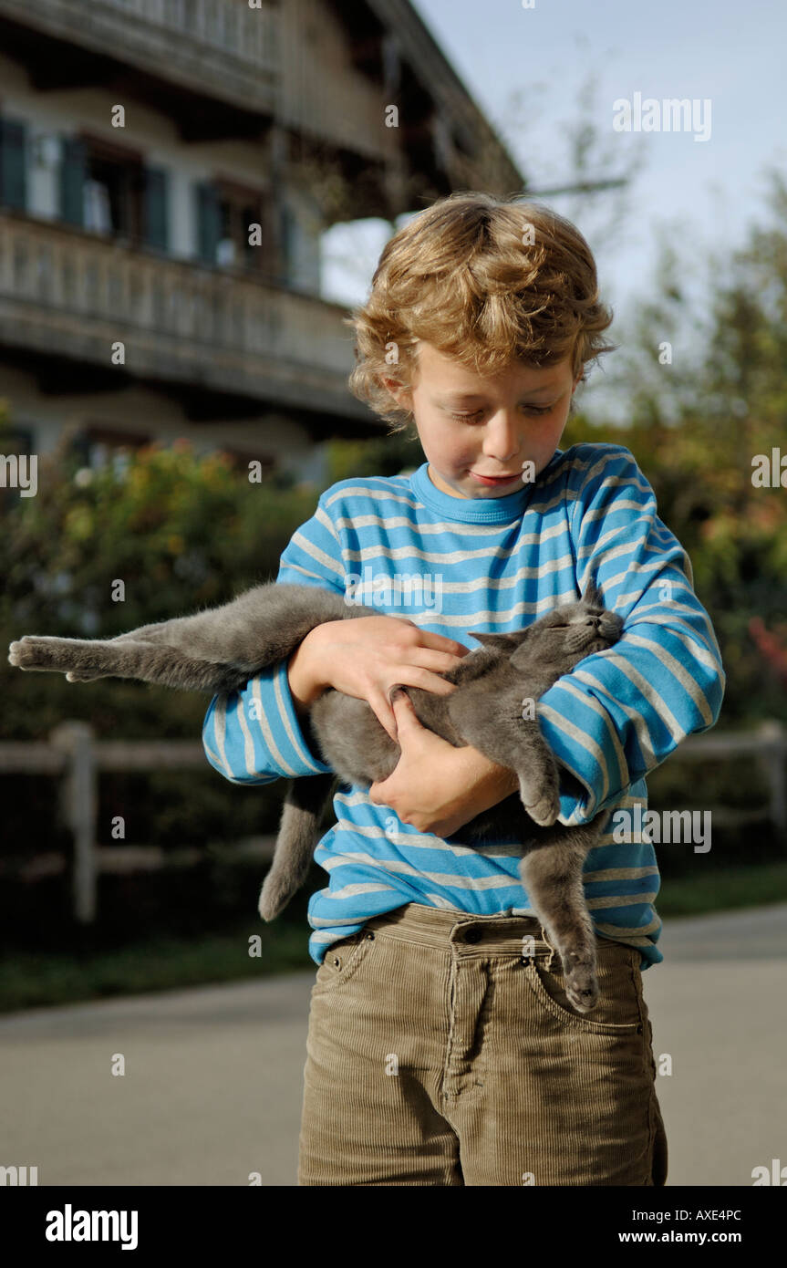 Boy with cat cuddling animals hi-res stock photography and images - Alamy
