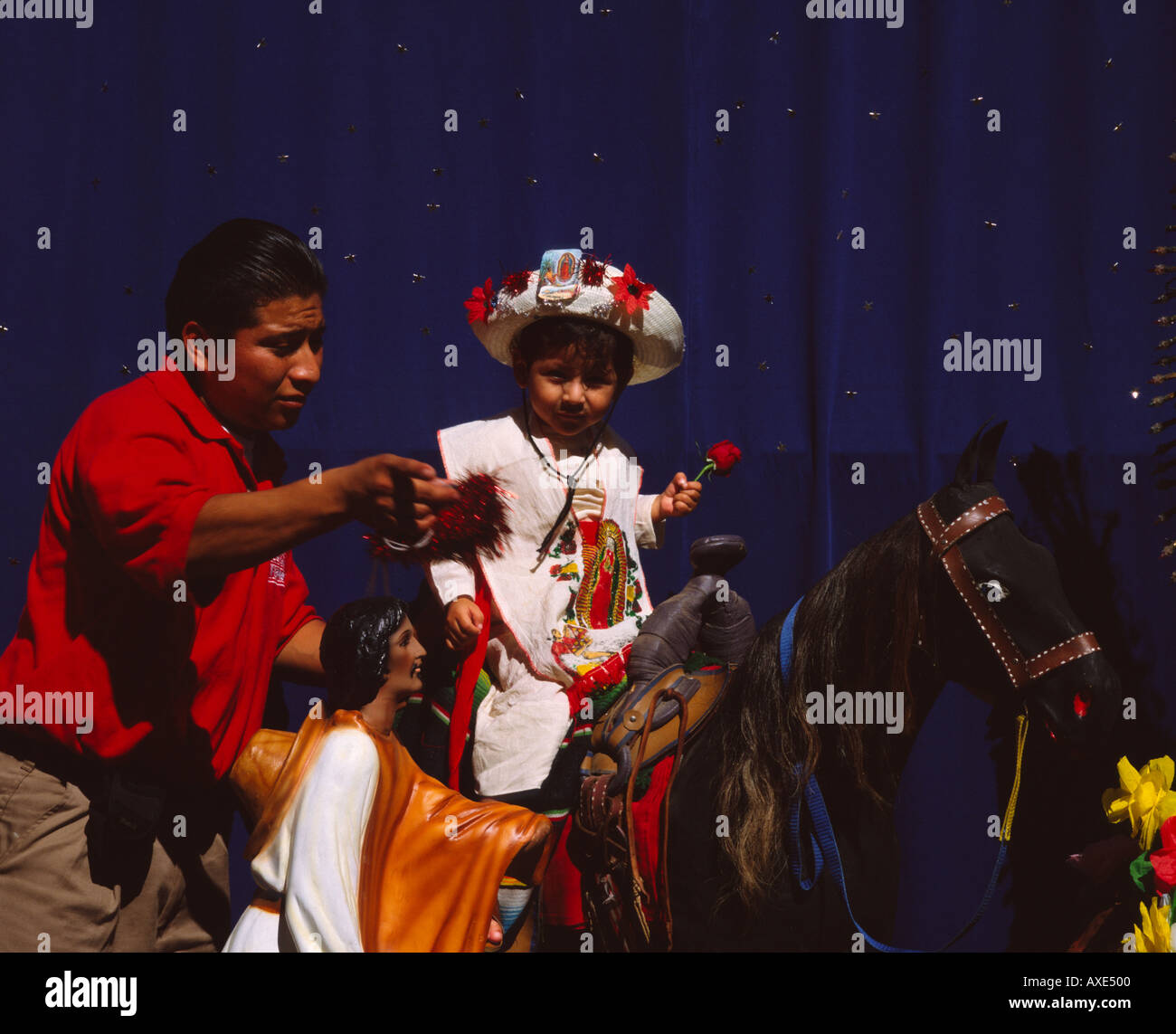 Child being photographed at the Feast of the Virgin of Guadalupe Oaxaca ...