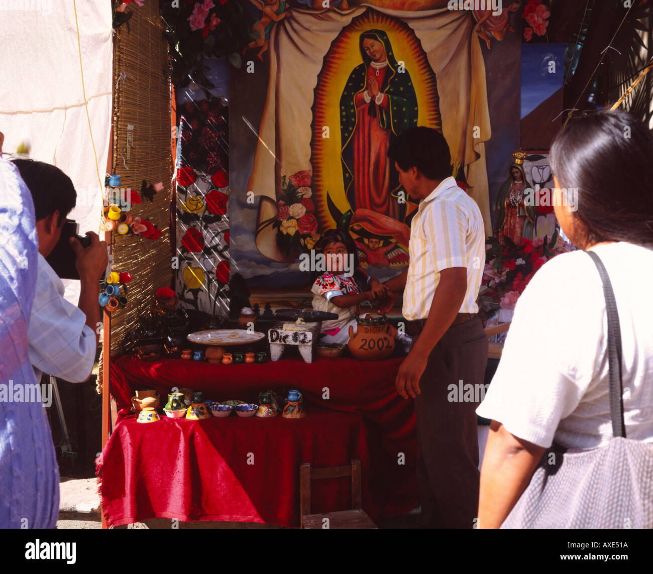 Child being posed by its father to be photographed at the Feast of the ...