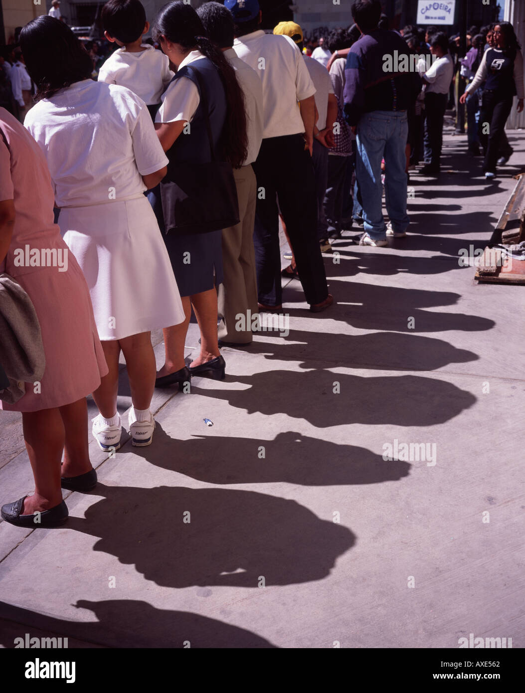 Shadows of spectators lining the route of a procession Oaxaca Mexico ...