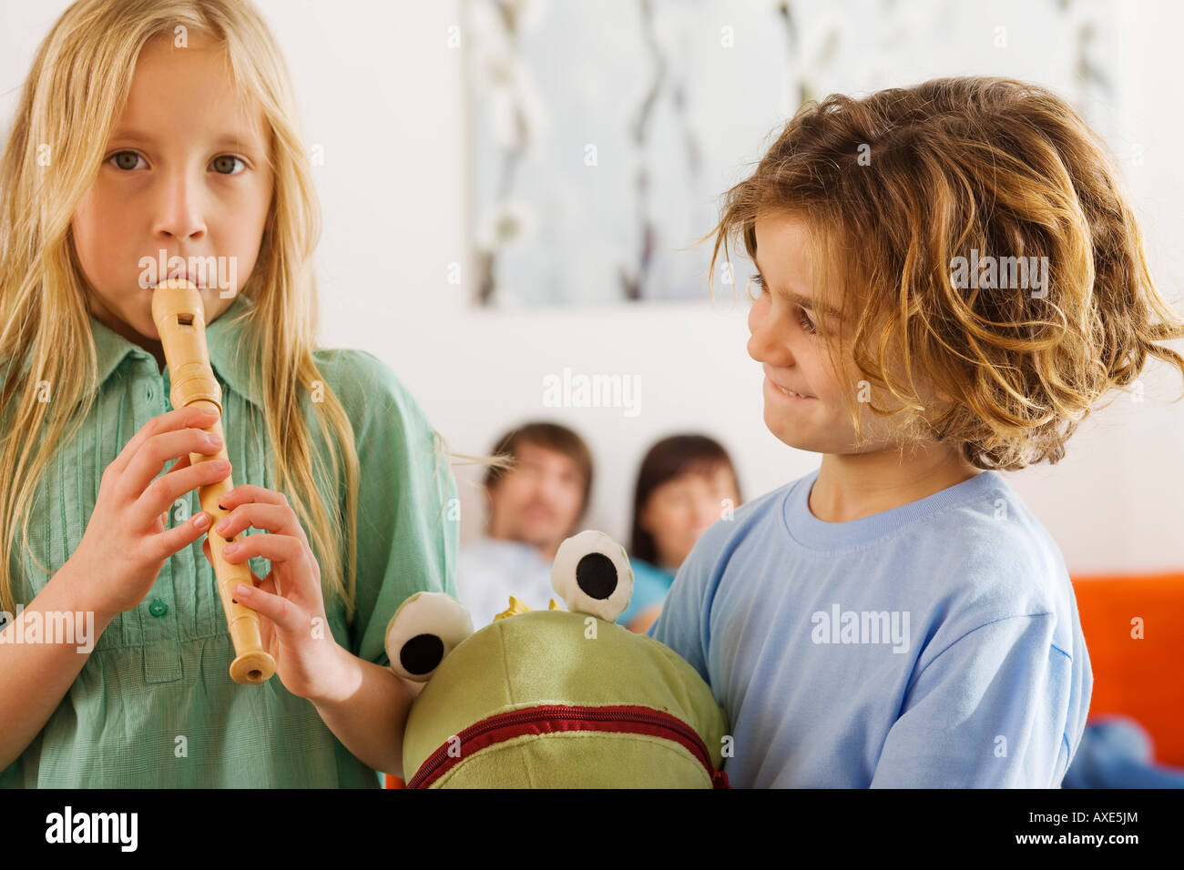 Boy (6-7) and girl (8-9), playing recorder, portrait Stock Photo - Alamy
