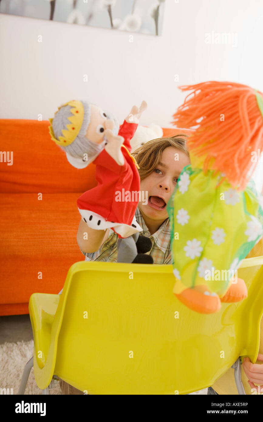 Boy (6-7) playing with glove puppets Stock Photo - Alamy
