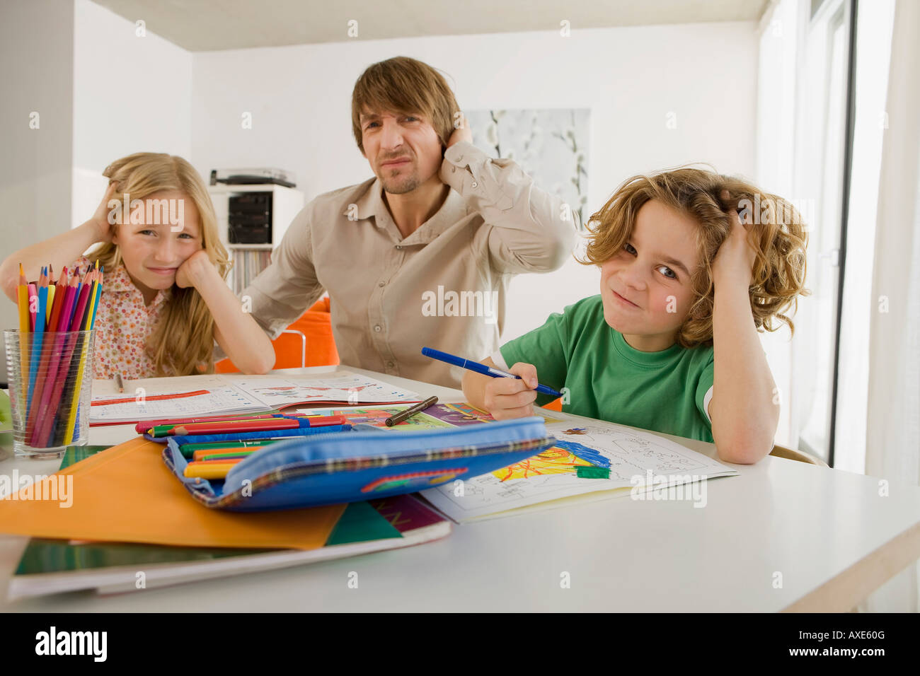 Father and children doing homework Stock Photo - Alamy