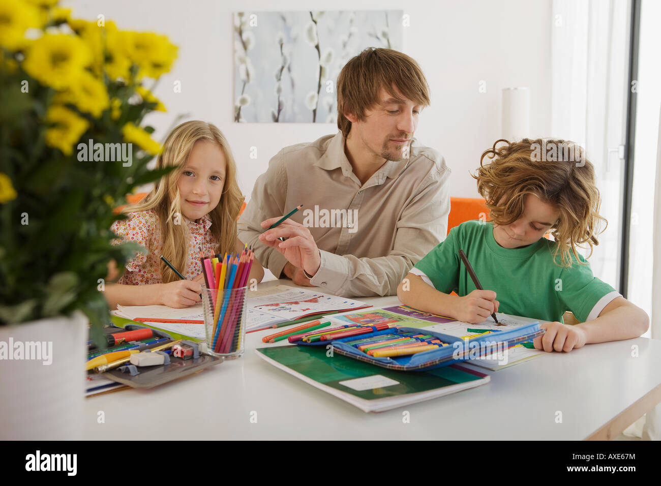 Father and children doing homework Stock Photo - Alamy