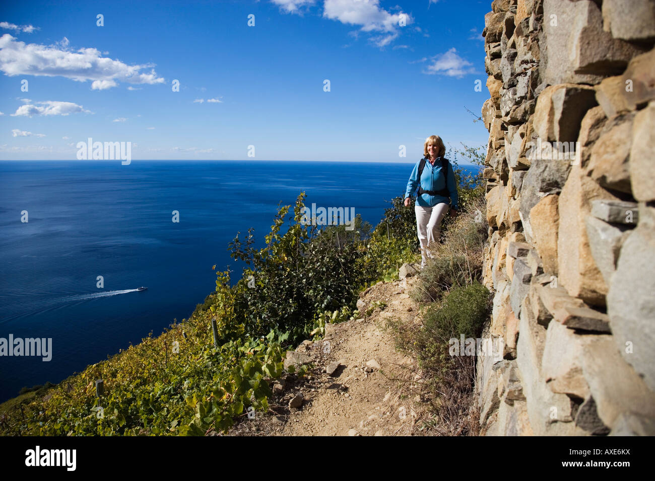 Italy, Liguria, Corniglia, Woman hiking on pathway Stock Photo - Alamy