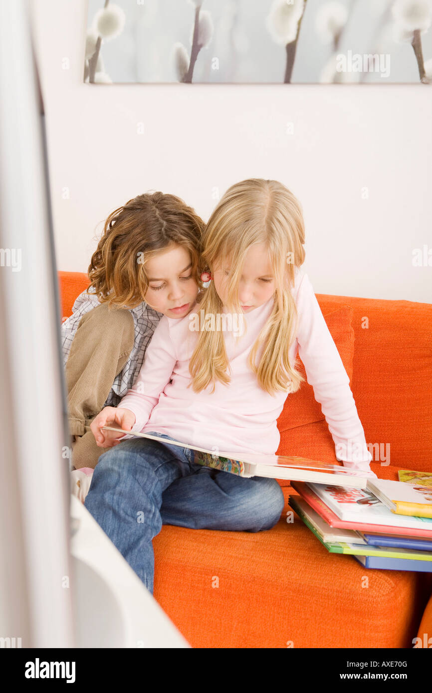 Brother and sister reading a book together Stock Photo - Alamy