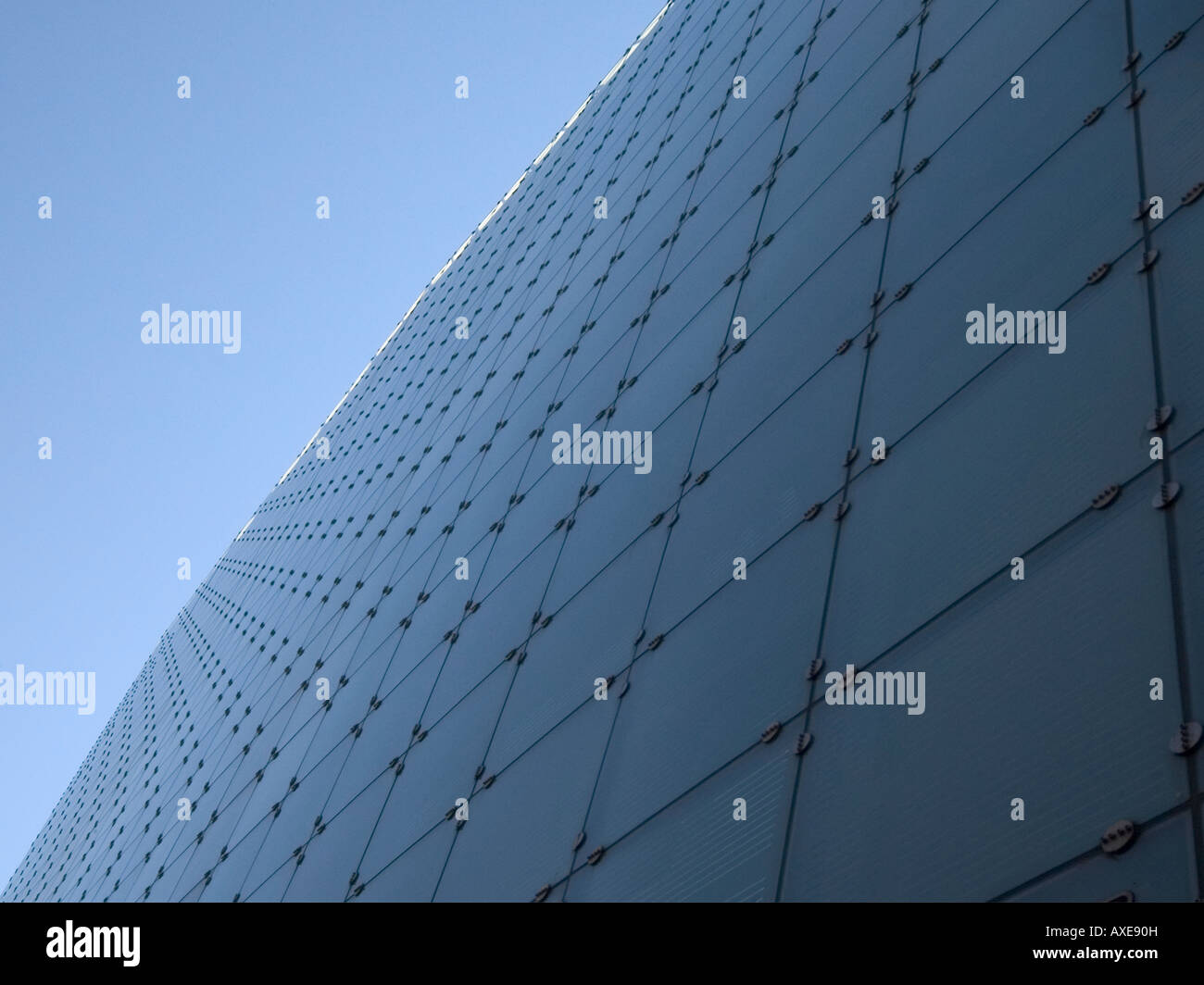 Windows of a large glass building at an angle Stock Photo - Alamy