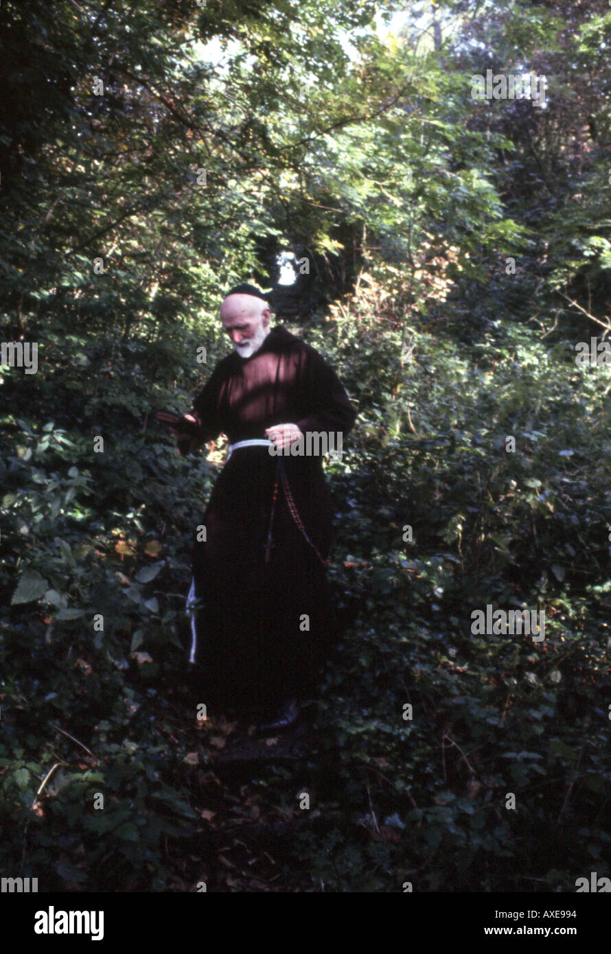 Monk in garden holding his bible Stock Photo - Alamy