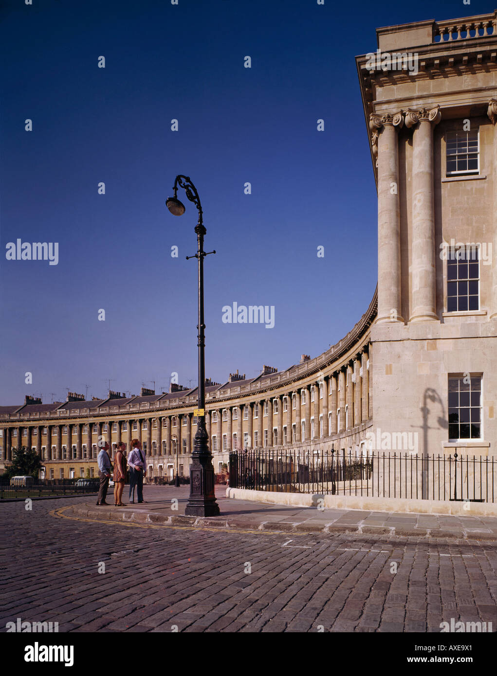 Trio of people admire the Royal Crescent famous semicircle of Georgian ...
