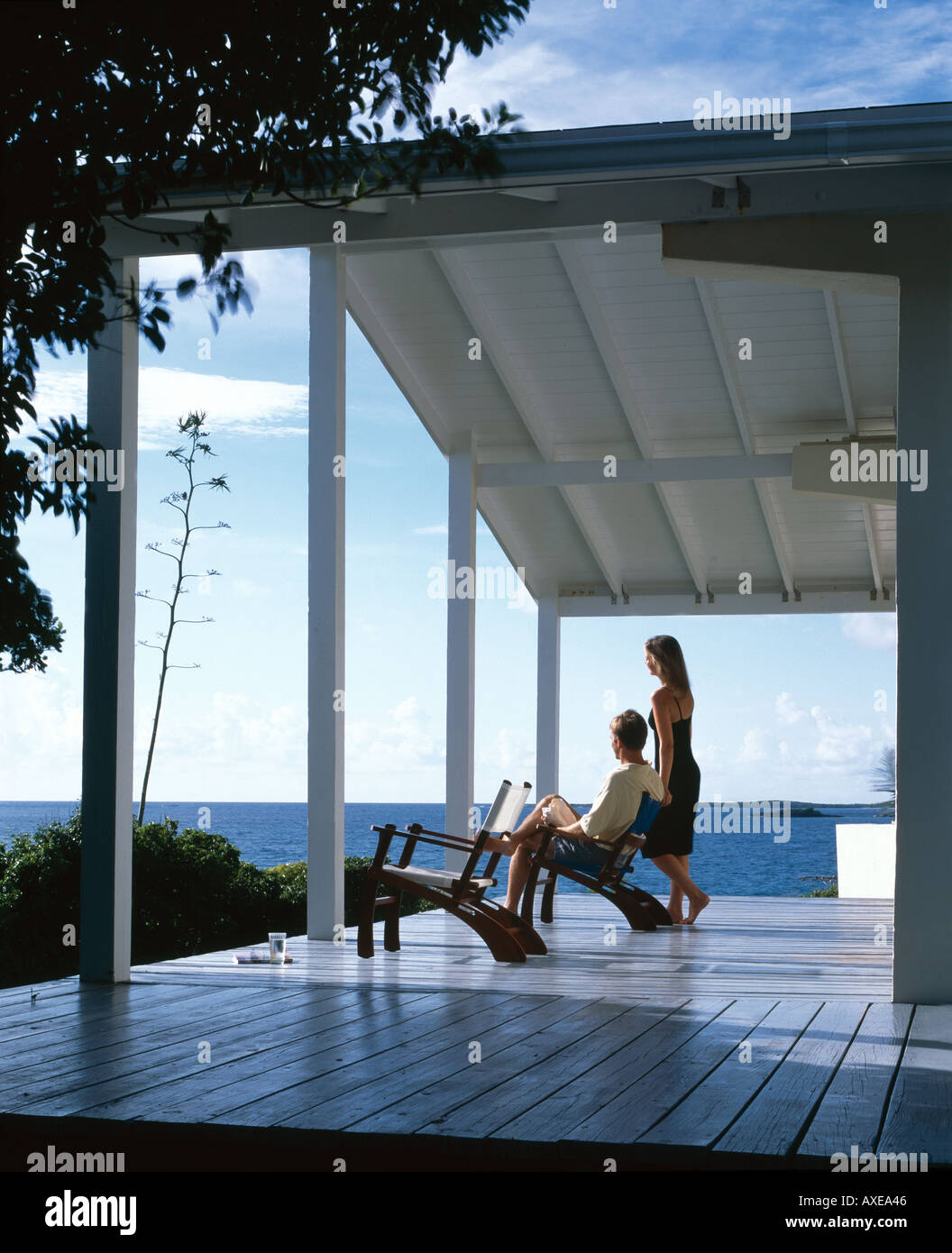 House on Channel Cay, Abacos Island, Bahamas. Verandah with couple ...