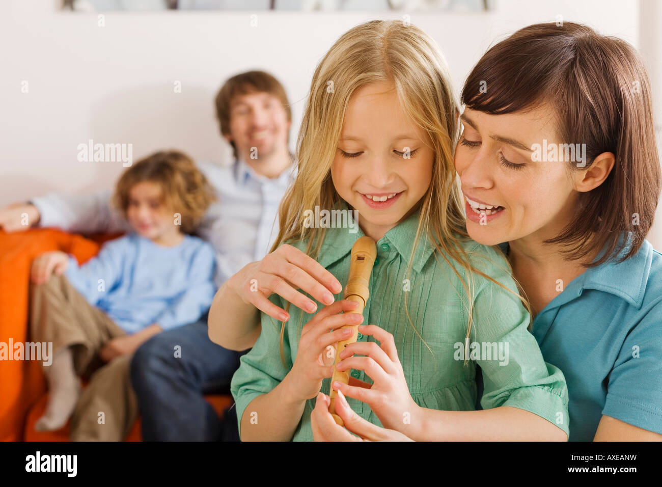 Mother and daughter (8-9), playing recorder Stock Photo - Alamy