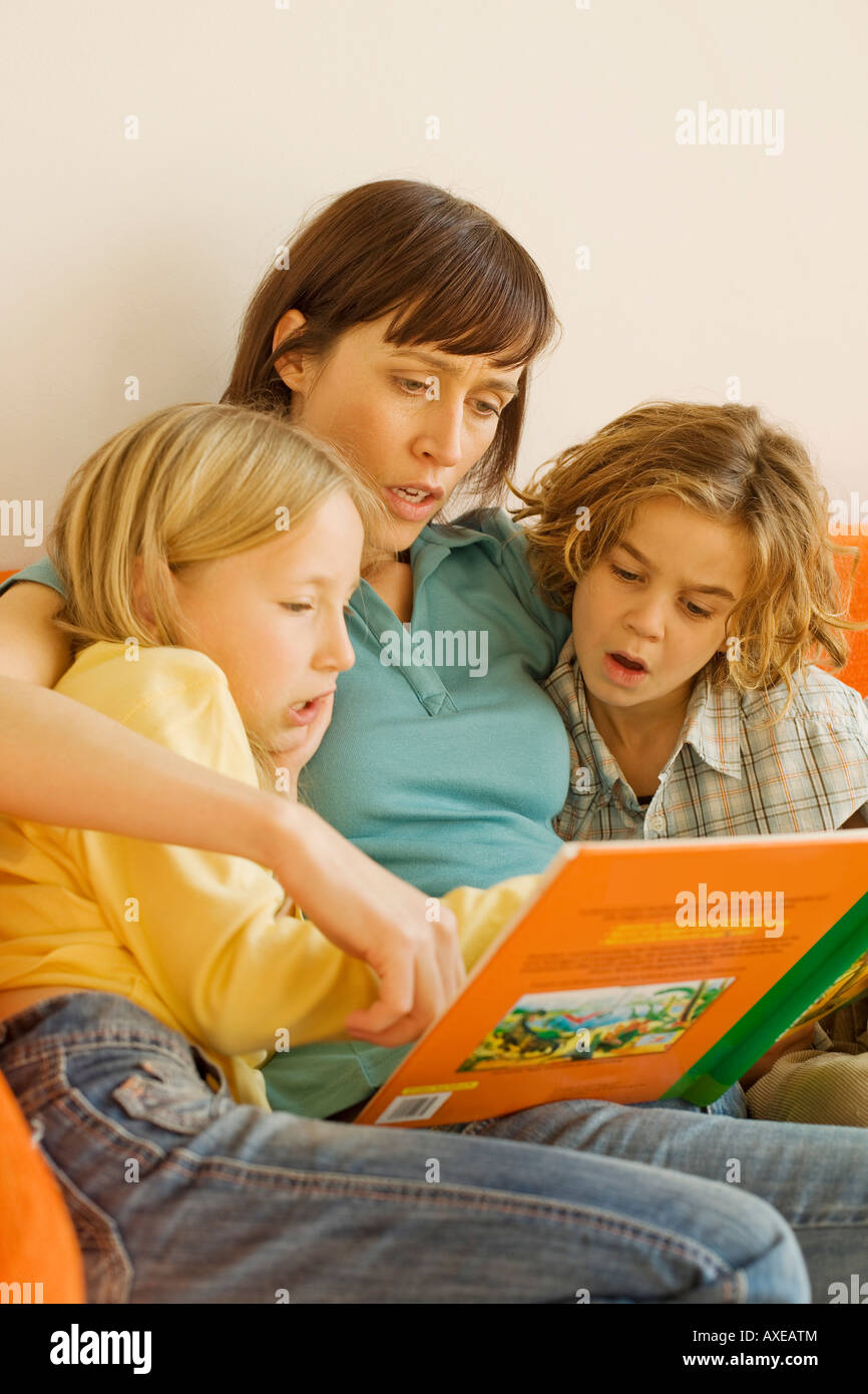 Mother reading story book to children Stock Photo - Alamy
