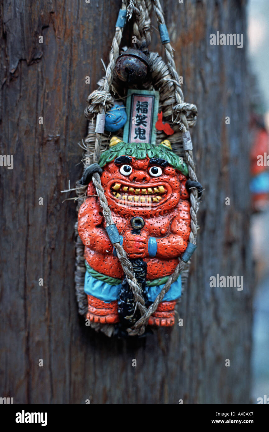 Small devilish oni figurine with firce features pinned to a tree Good ...