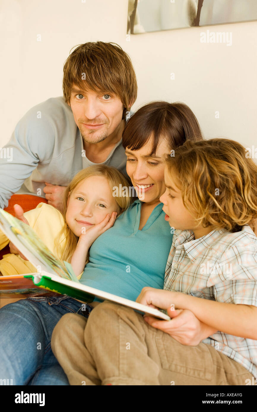 Family reading story book in living room Stock Photo - Alamy