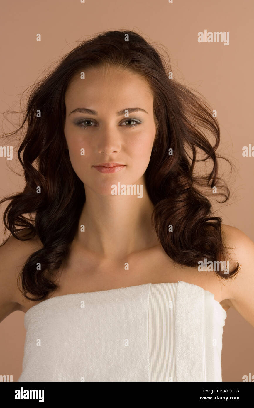 Young woman wearing towel, smiling, portrait Stock Photo - Alamy