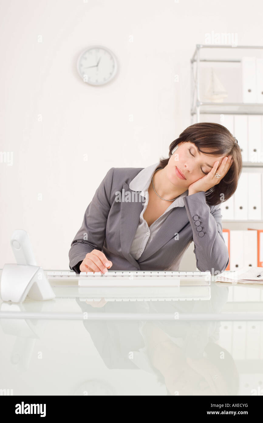 Businesswoman weary with working, hand to head Stock Photo - Alamy