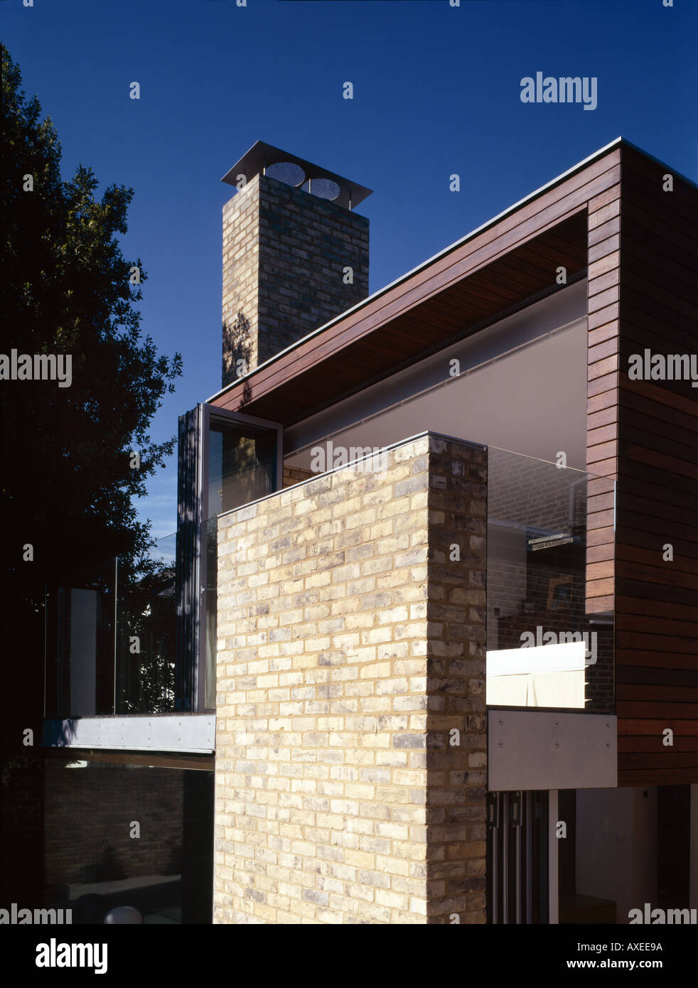House Extension, Chiswick. Balcony with sliding doors open. Architect ...