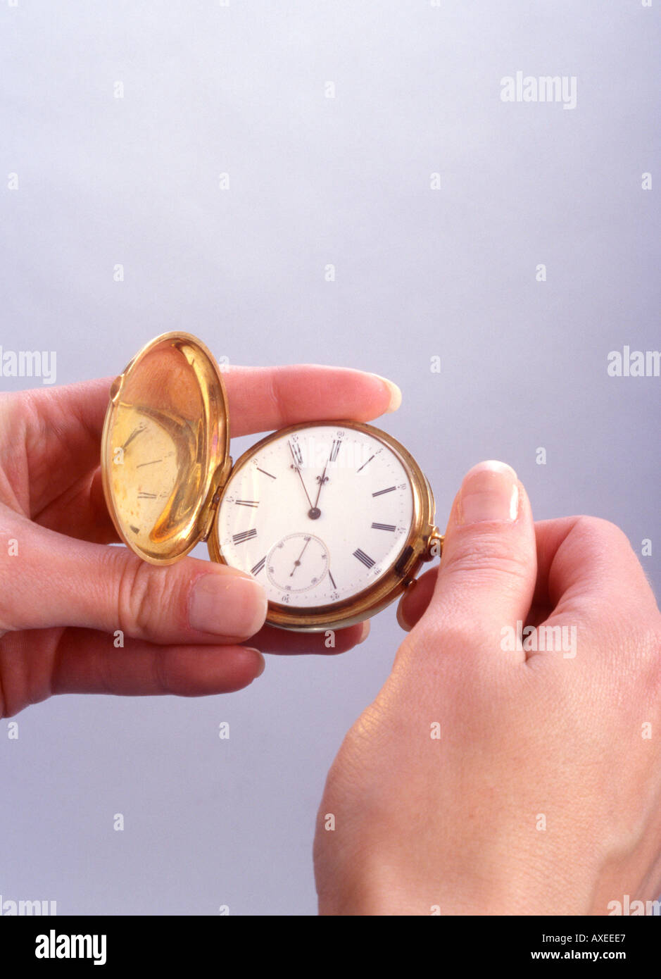 hands setting time on pocket watch Stock Photo - Alamy
